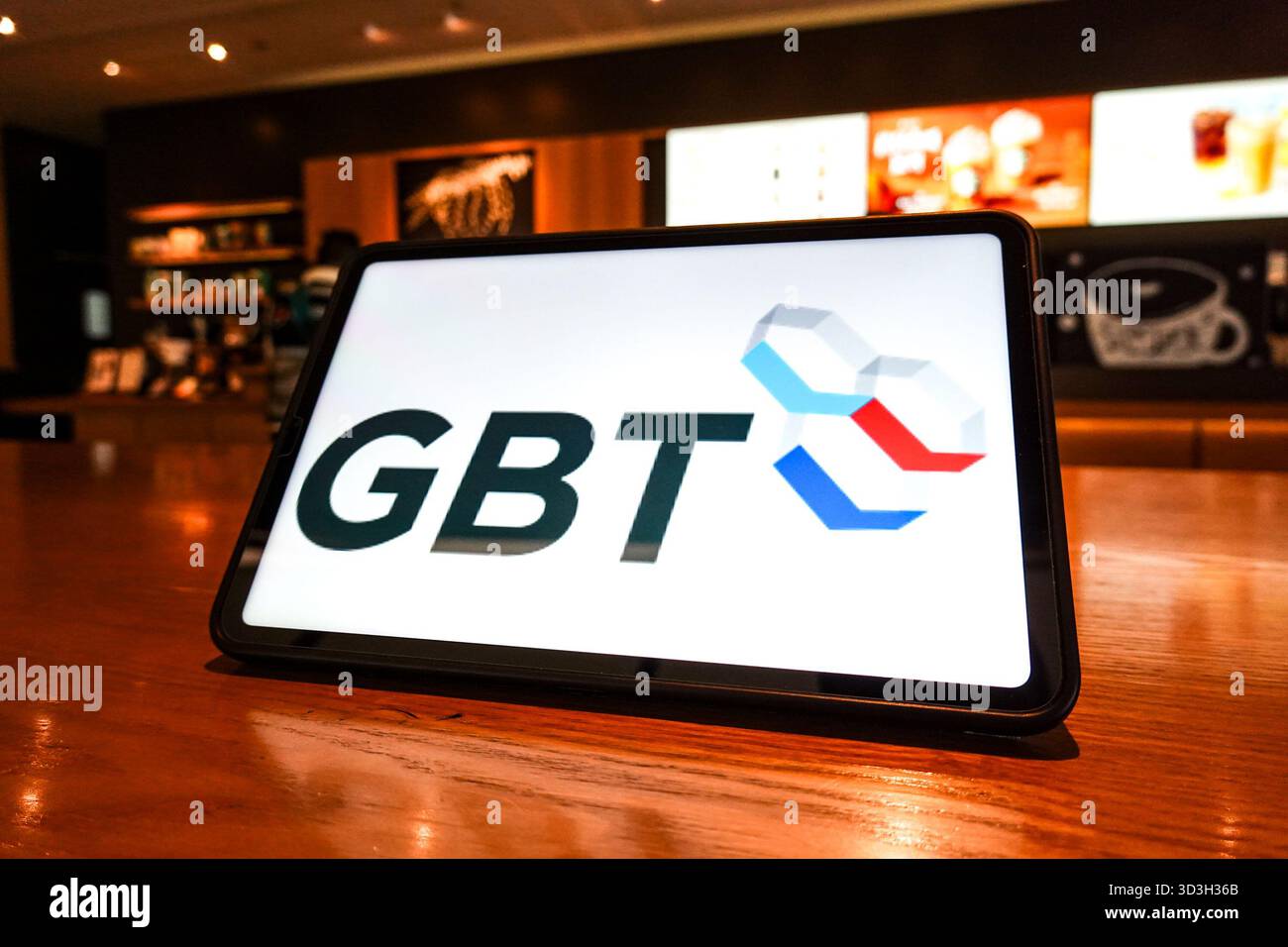 In this photo illustration, the GBT logo is displayed on the screen of ...