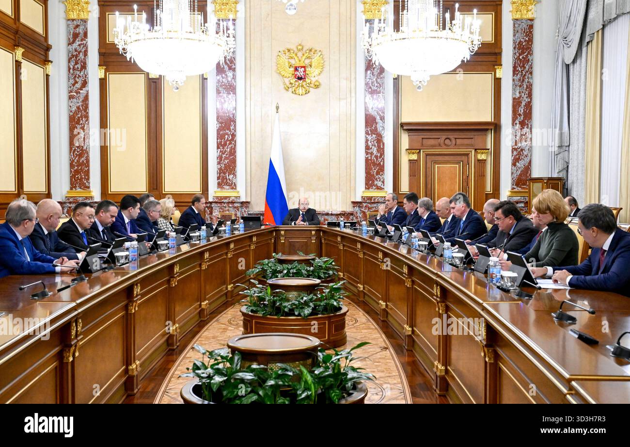 Russian Prime Minister Mikhail Mishustin, rear center, leads a cabinet ...