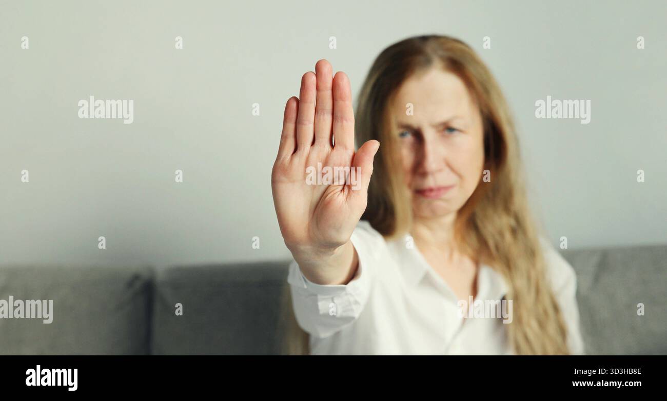 Close-up suffering woman shows stop, no or protest sign with palm of ...