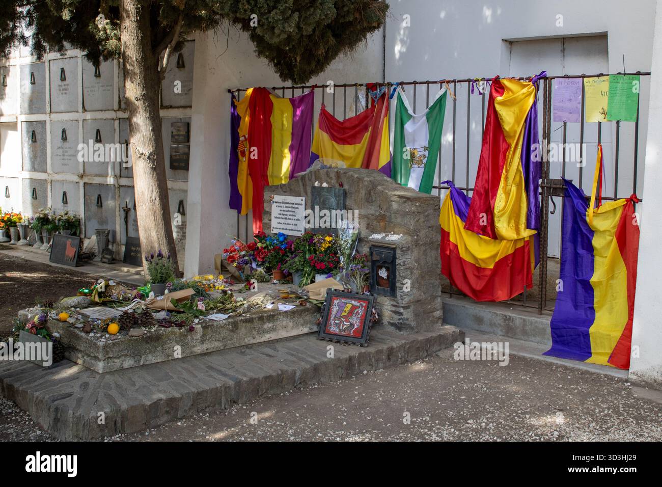 Antonio machado's grave adorned with flowers and republican flags ...