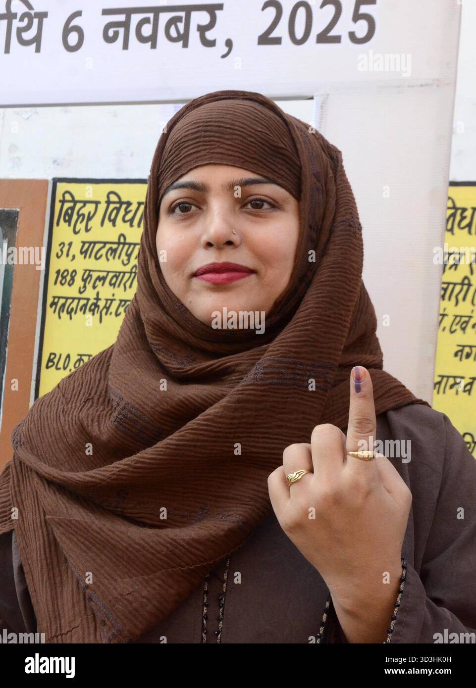 PATNA, INDIA - NOVEMBER 6: A voter showing ink marks after cast her ...