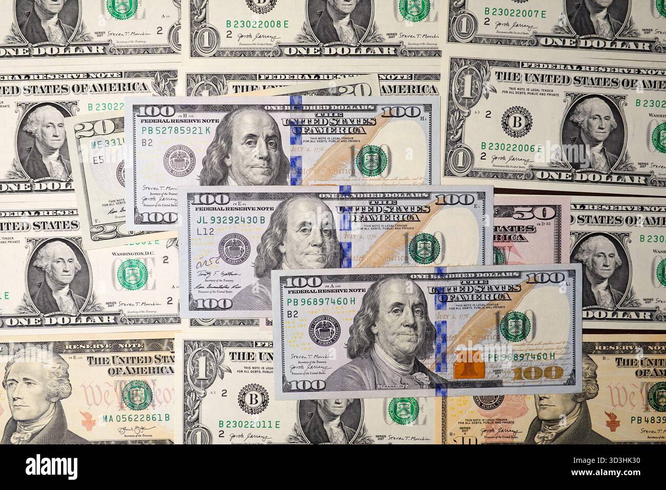 In this photo illustration, multiple $100 US dollar bills placed on a ...