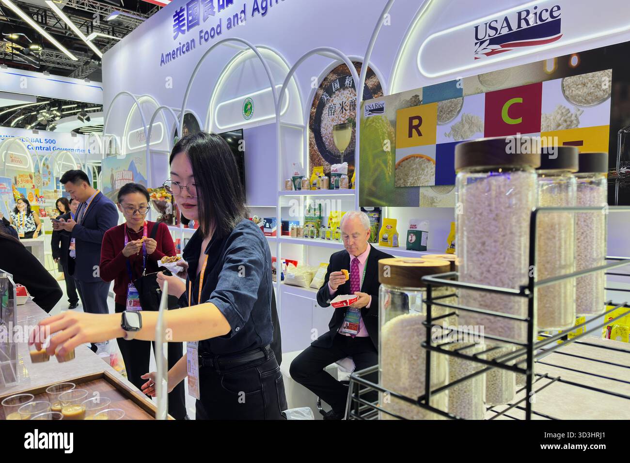 Visitors try out the snack foods and drinks made from rice at the ...