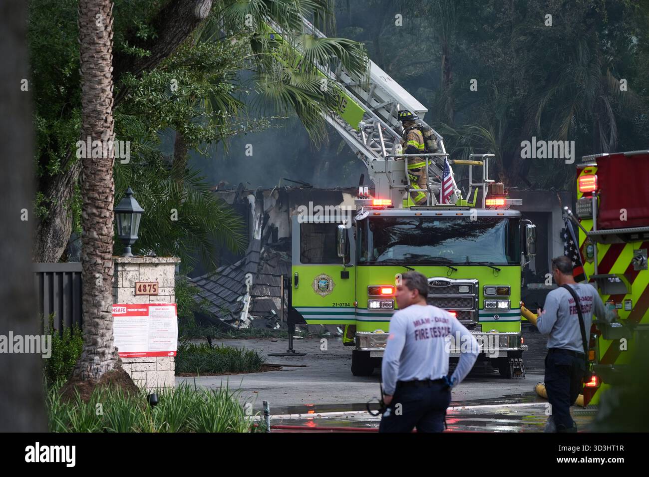Miami-Dade County Fire Rescue works to extinguish the remains of a fire ...