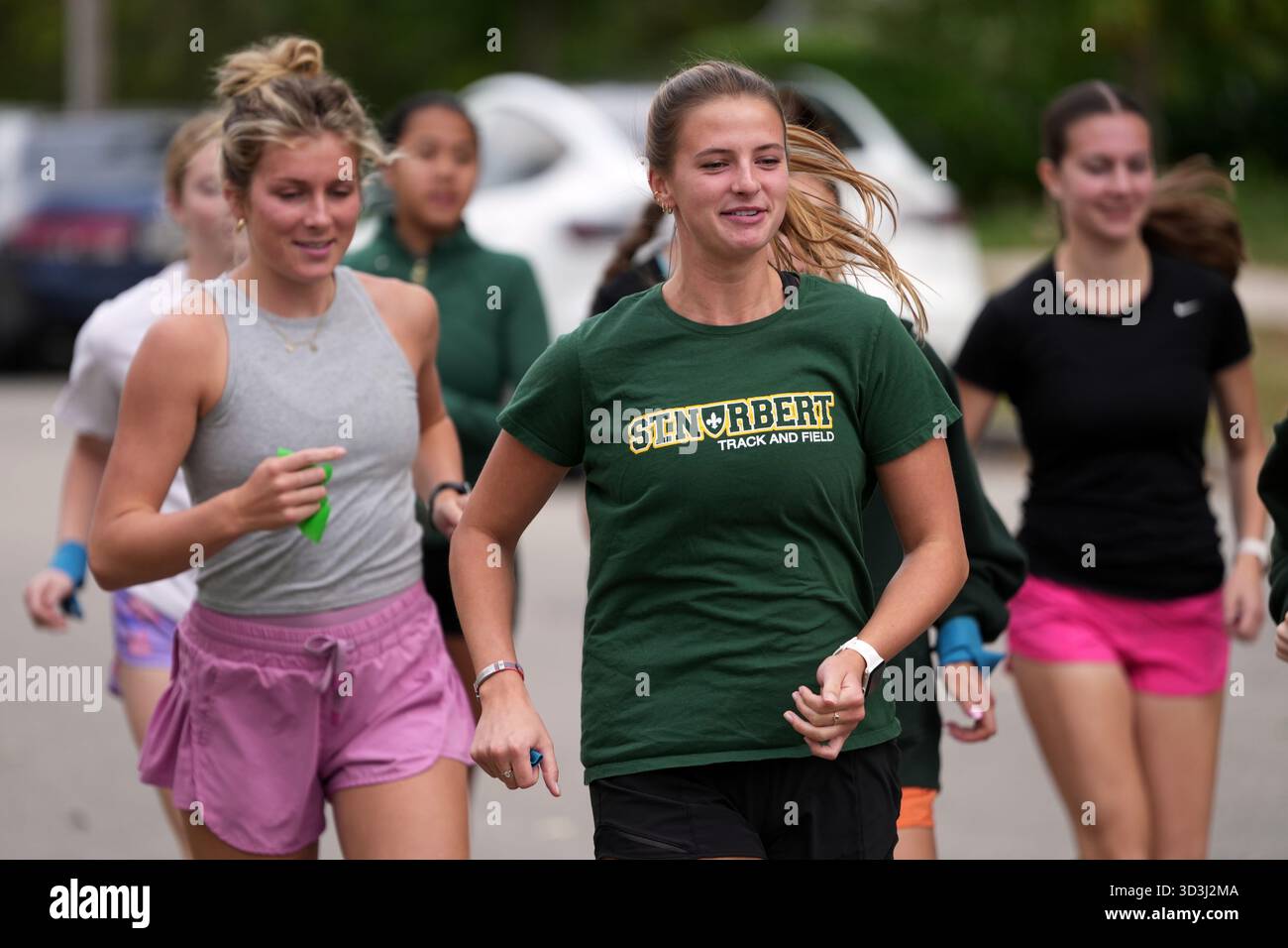 Cross country runner Madison DeCleene runs with her St. Norbert College ...