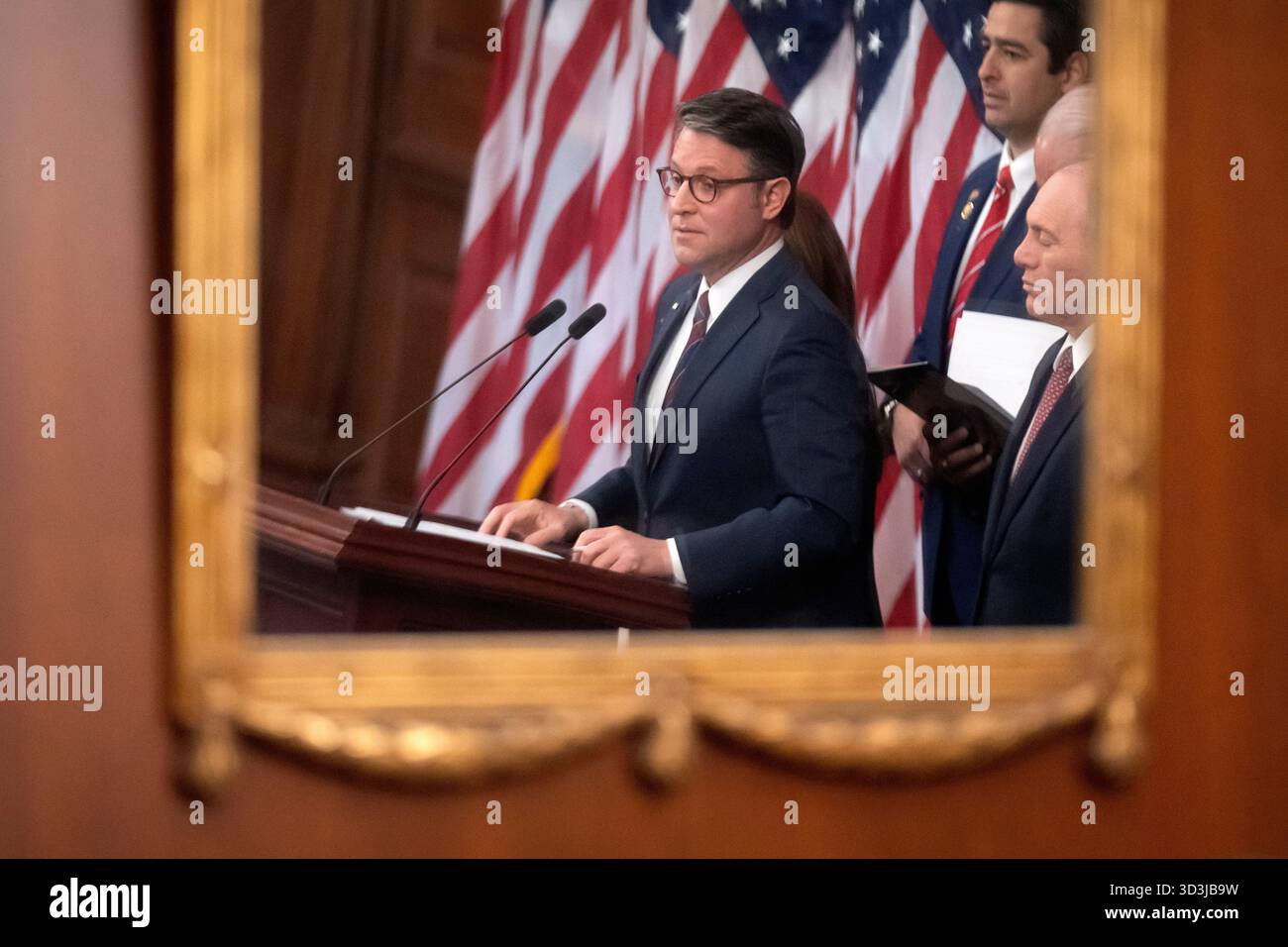 Speaker of the House Mike Johnson, R-La., is reflected in a mirror as ...