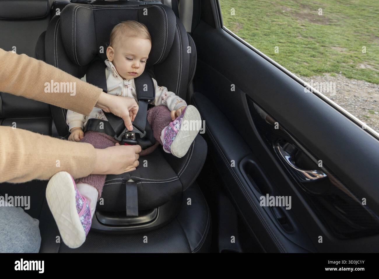 Mother putting safety belt hi-res stock photography and images - Alamy