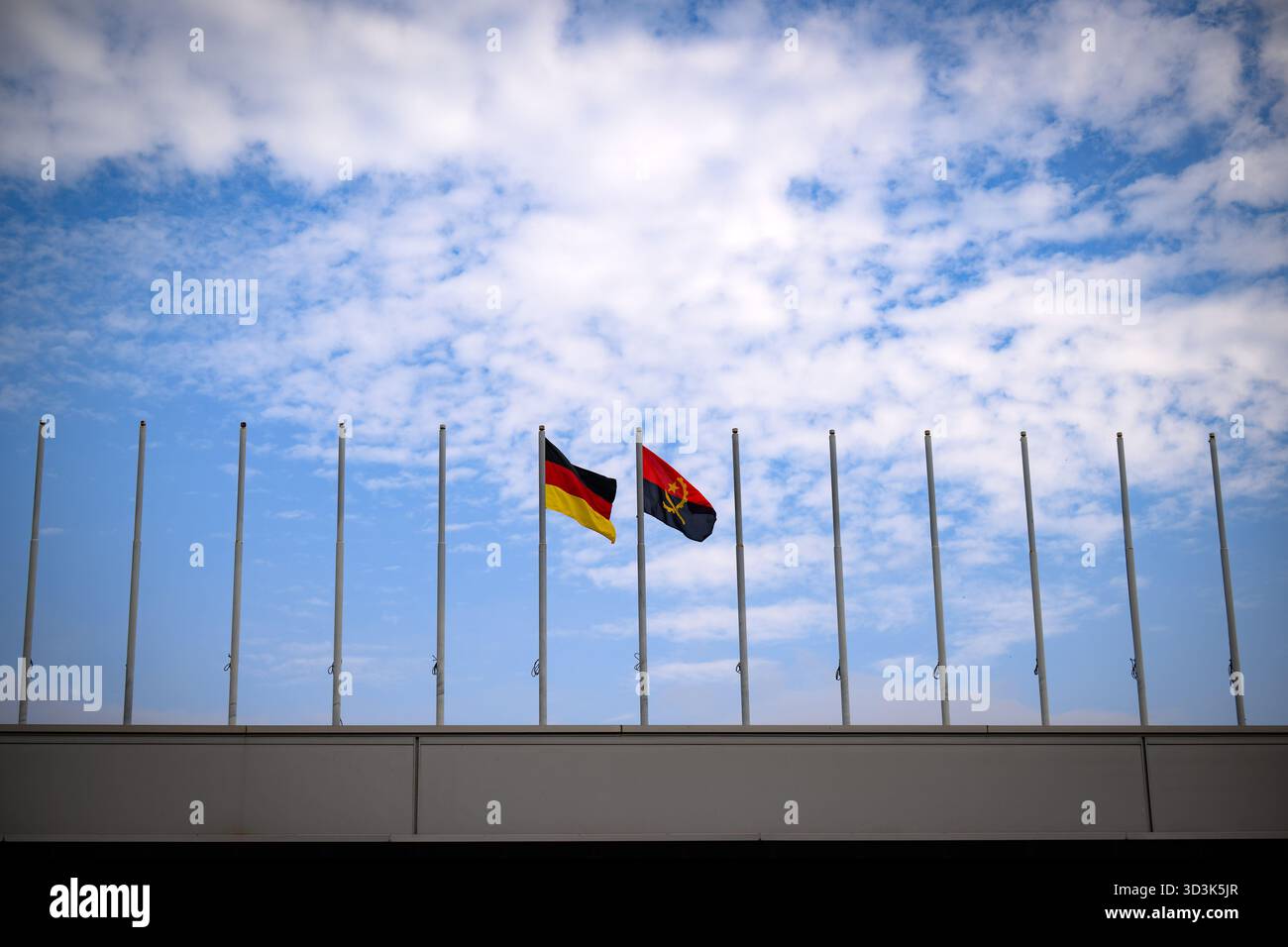 06 November 2025, Angola, Luanda: A German and an Angolan flag fly at ...