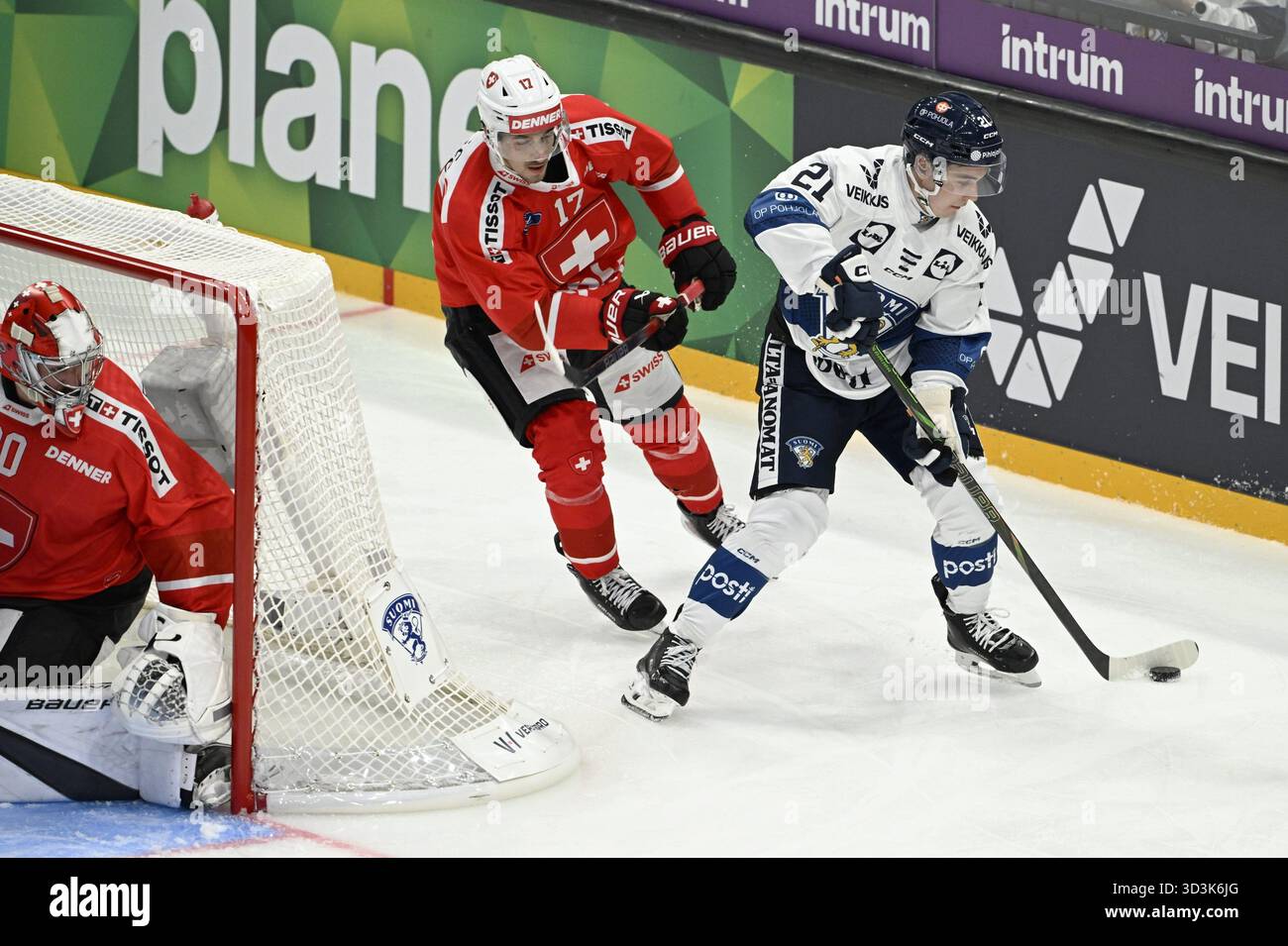 Ken Jager of Switzerland vies with Jere Innala of Finland, right ...