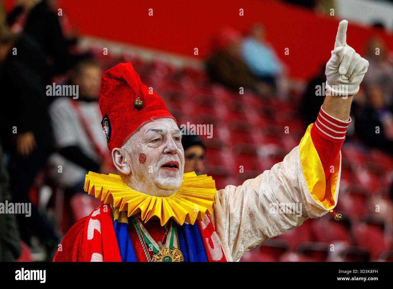 A Mainz fan in carnival costume and painted face is getting ready for ...