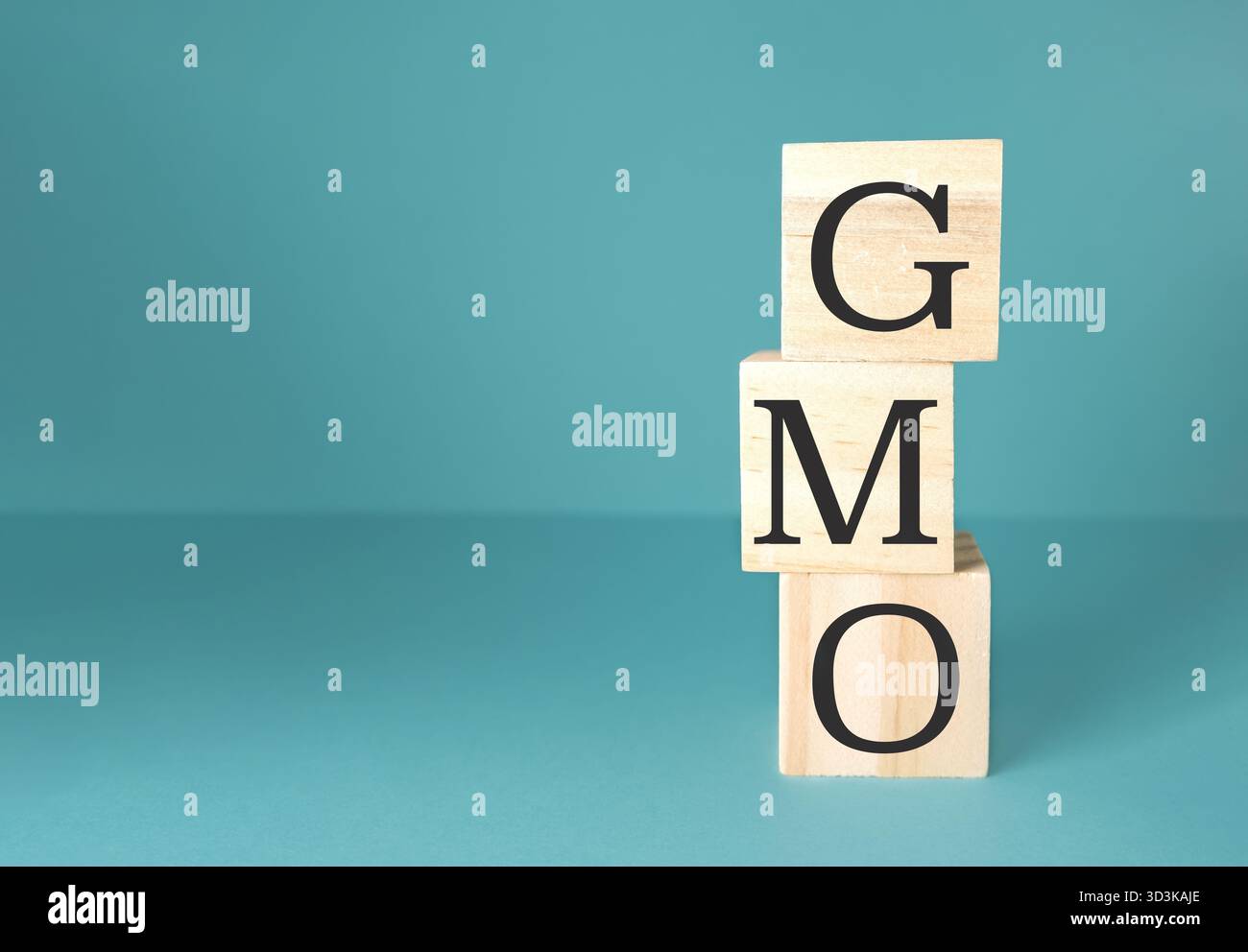 The image is a stack of wooden blocks with the letters GMO on top ...