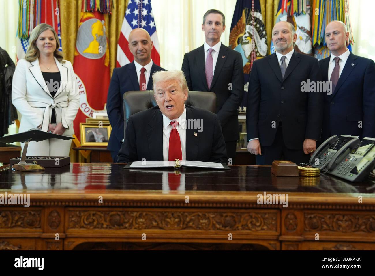 President Donald Trump speaks as Heidi Overton, deputy director of the ...