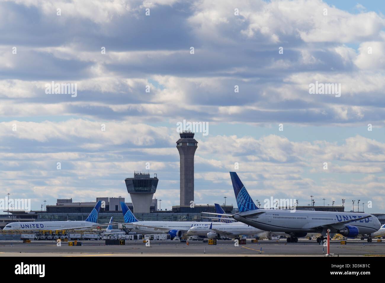 Planes are seen in front of an air traffic control tower at Newark ...