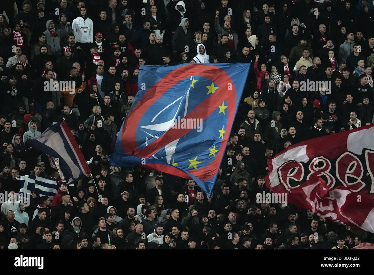 Red Star fans hold an anti NATO and European Union flag during the ...