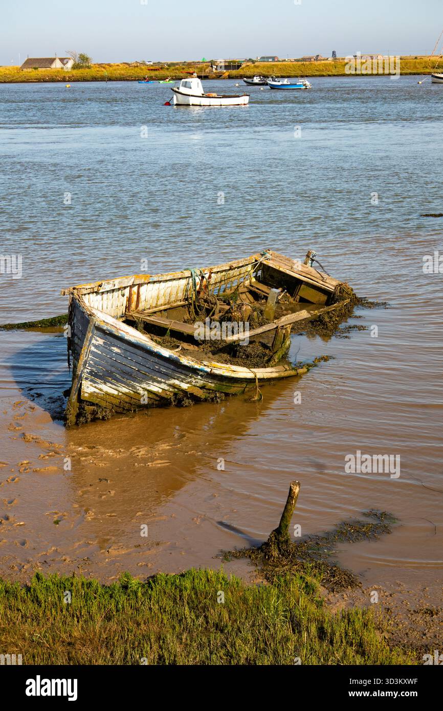Old rotted wreck half sunk boat in the river Ore near Orford Suffolk ...