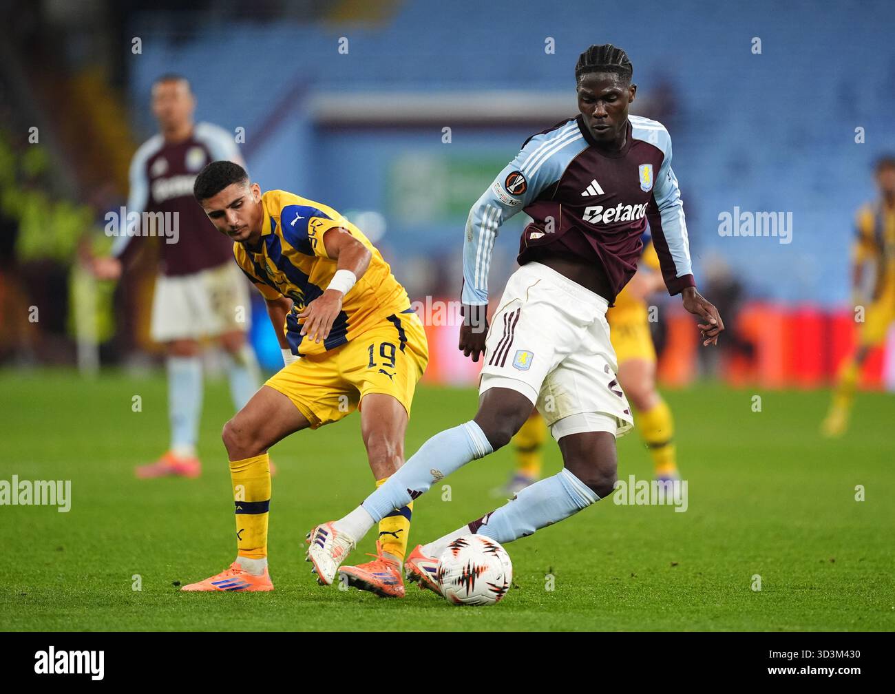 Maccabi Tel-Aviv's Elad Madmon (left) and Aston Villa's Amadou Onana in ...