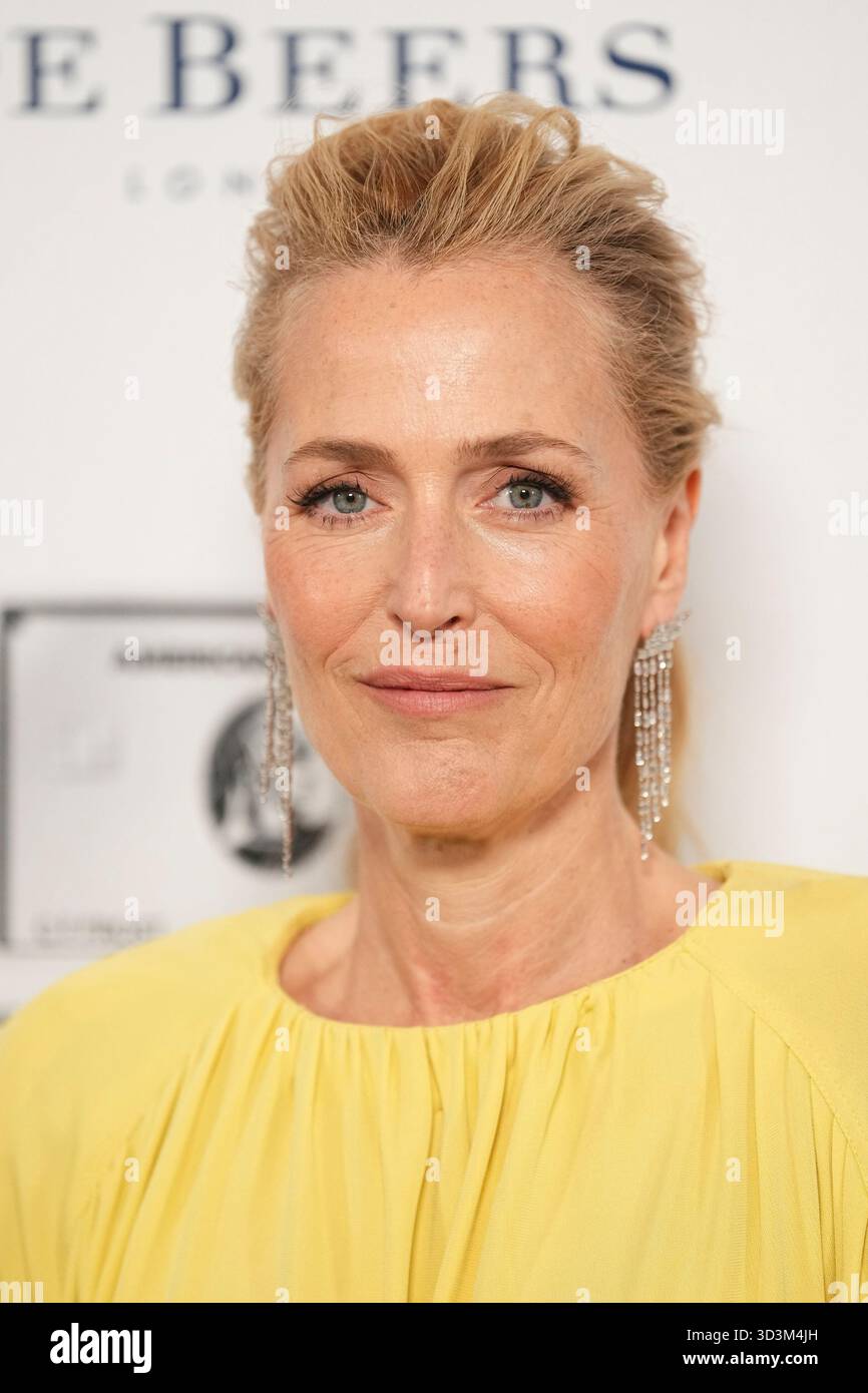 Gillian Anderson poses for photographers upon arrival at the Harper's ...