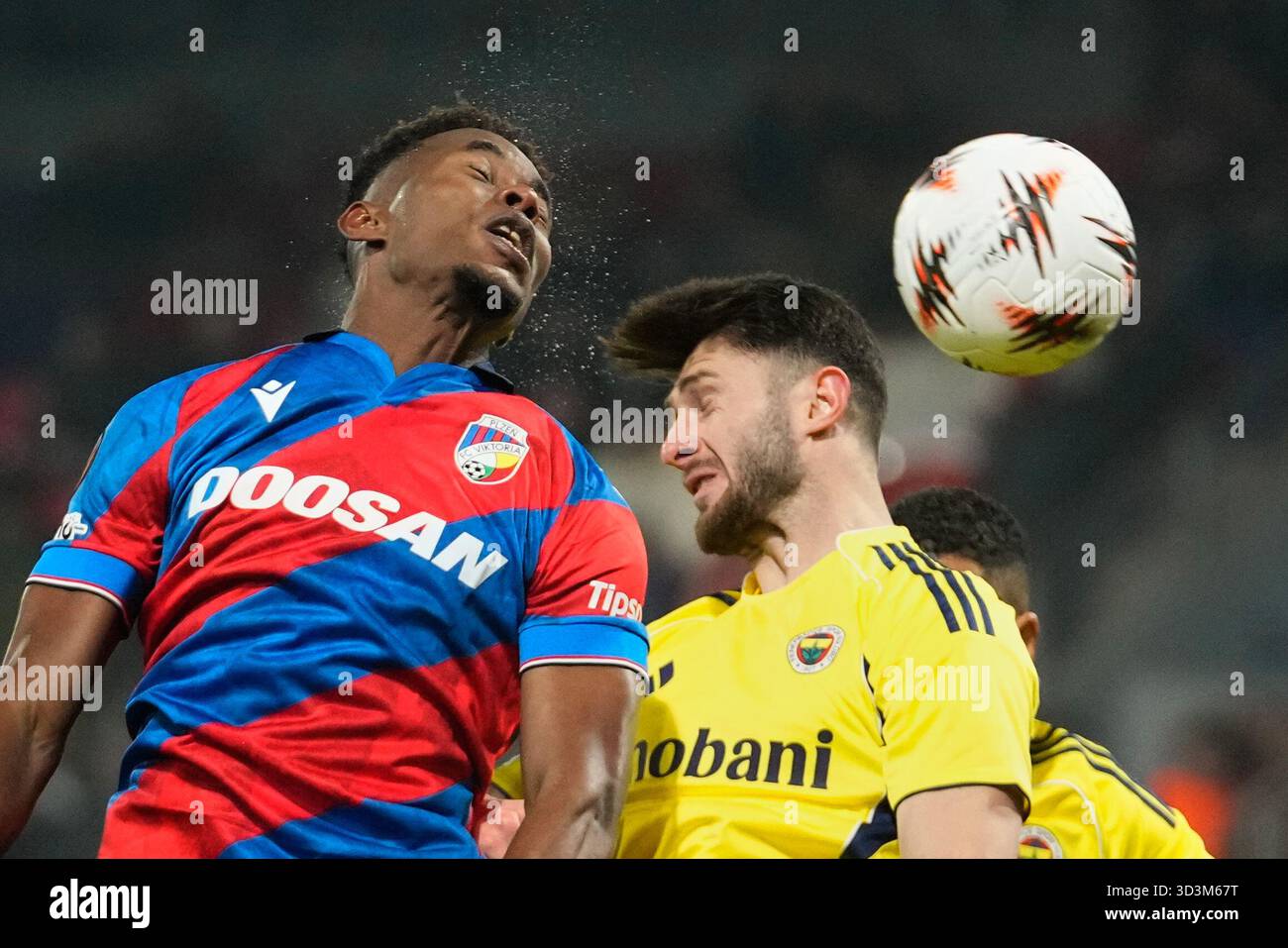 Plzen's Sampson Dweh, left, heads the ball past Fenerbahce's Ismail ...