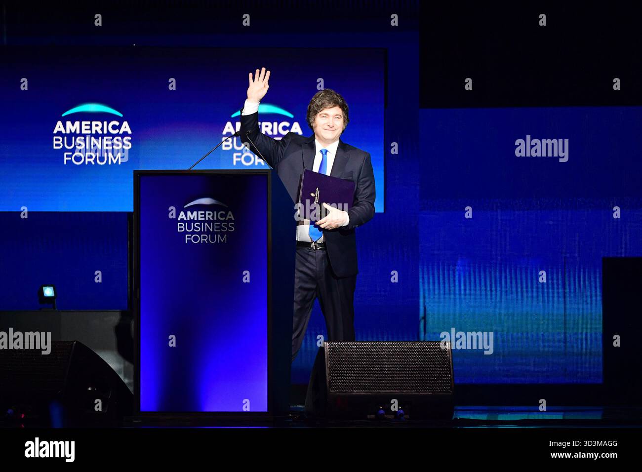 President of Argentina Javier Milei waves to the crowd as he walks onto ...