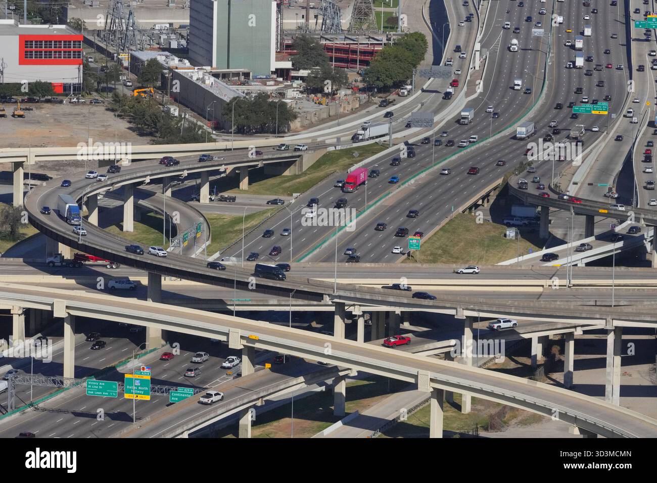Vehicles travel along a Interstate-35E near buildings in the Dallas ...