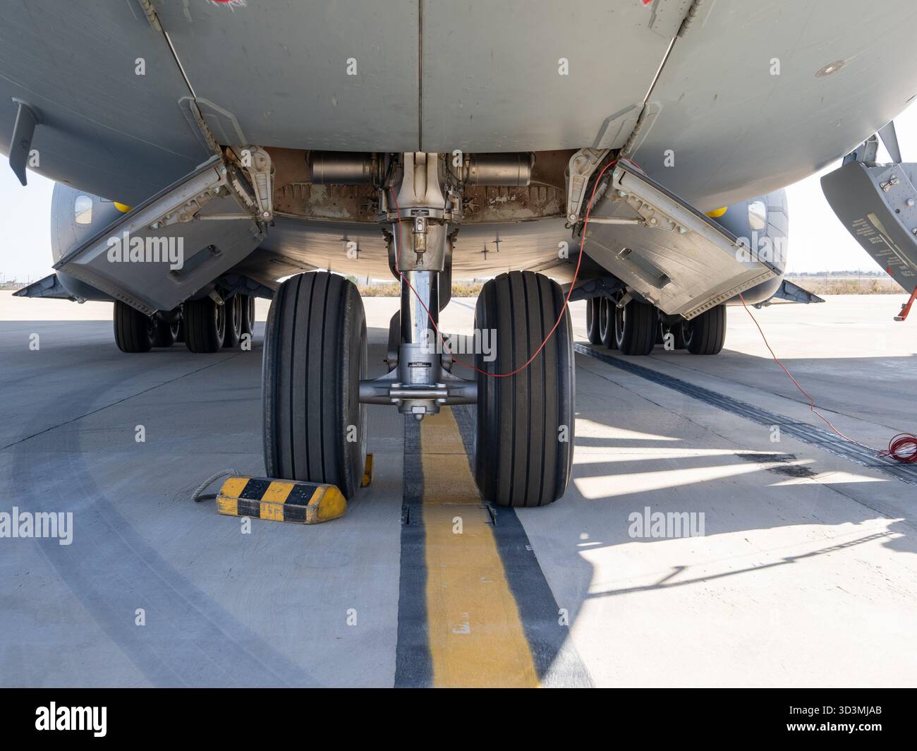 Aircraft nose landing gear on runway centerline Stock Photo - Alamy