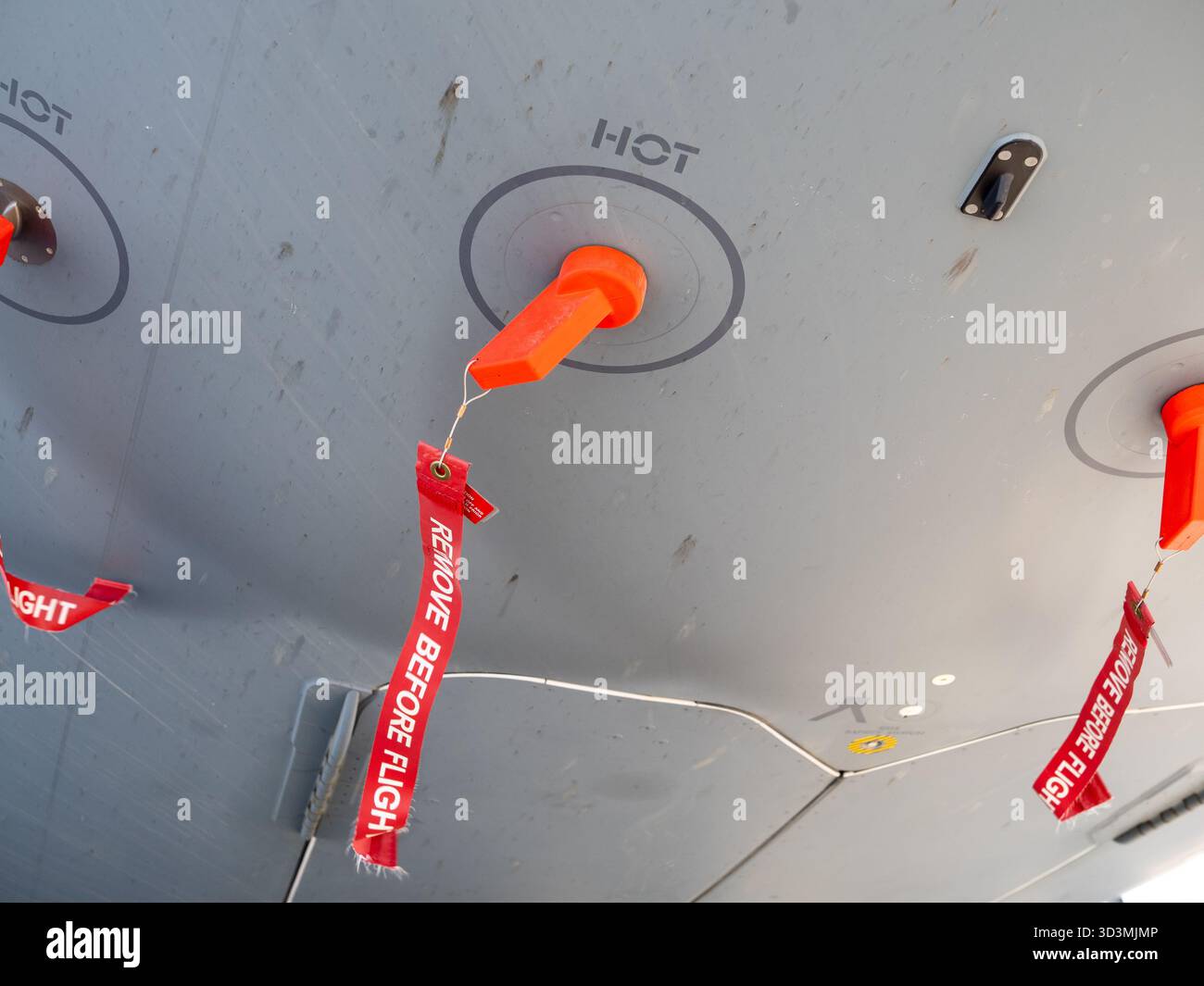 Remove before flight safety plugs under aircraft fuselage Stock Photo ...