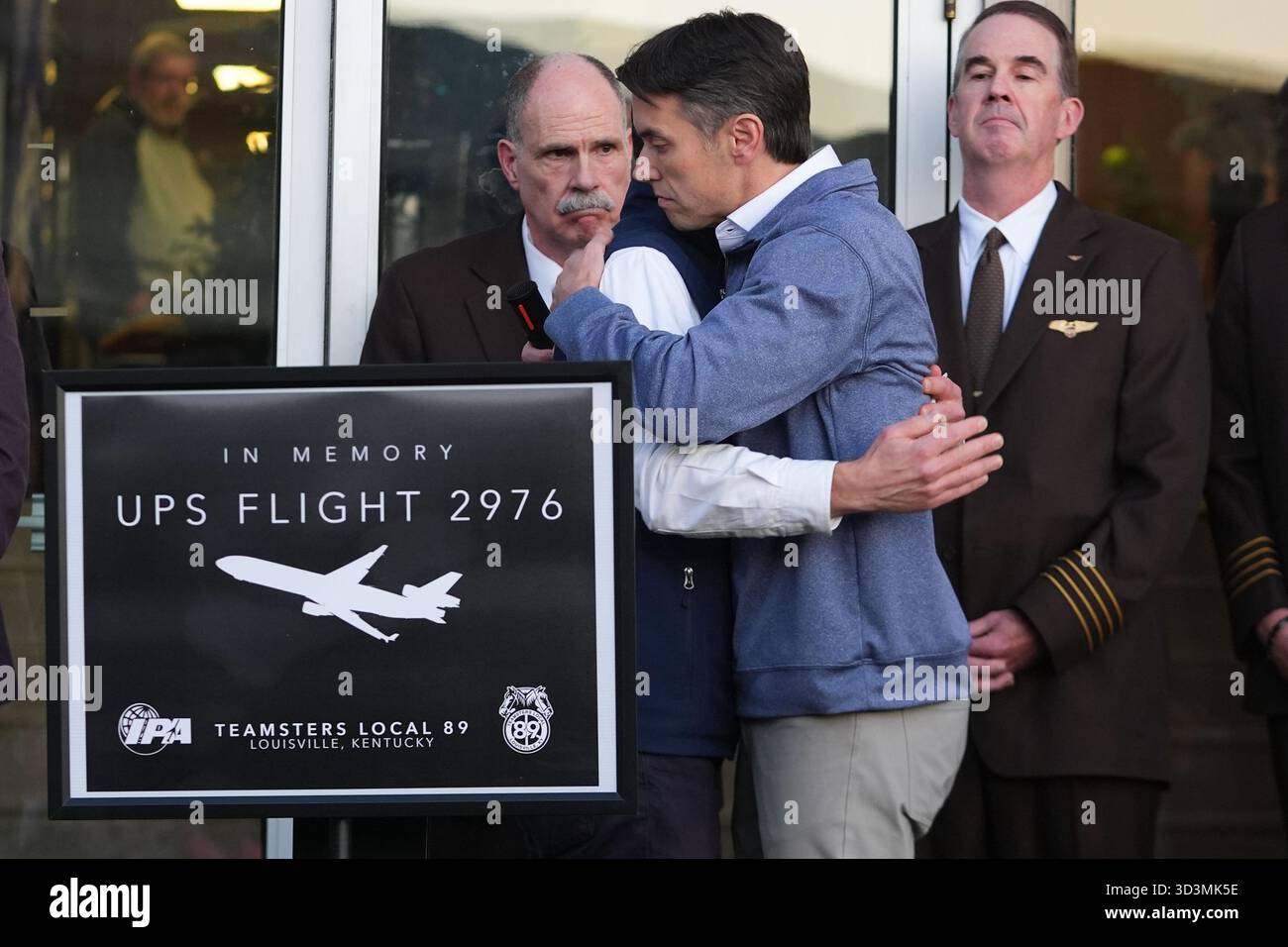 Mayor Craig Greenberg, center left, hugs Rep. Morgan McGarvey, D-Ky ...