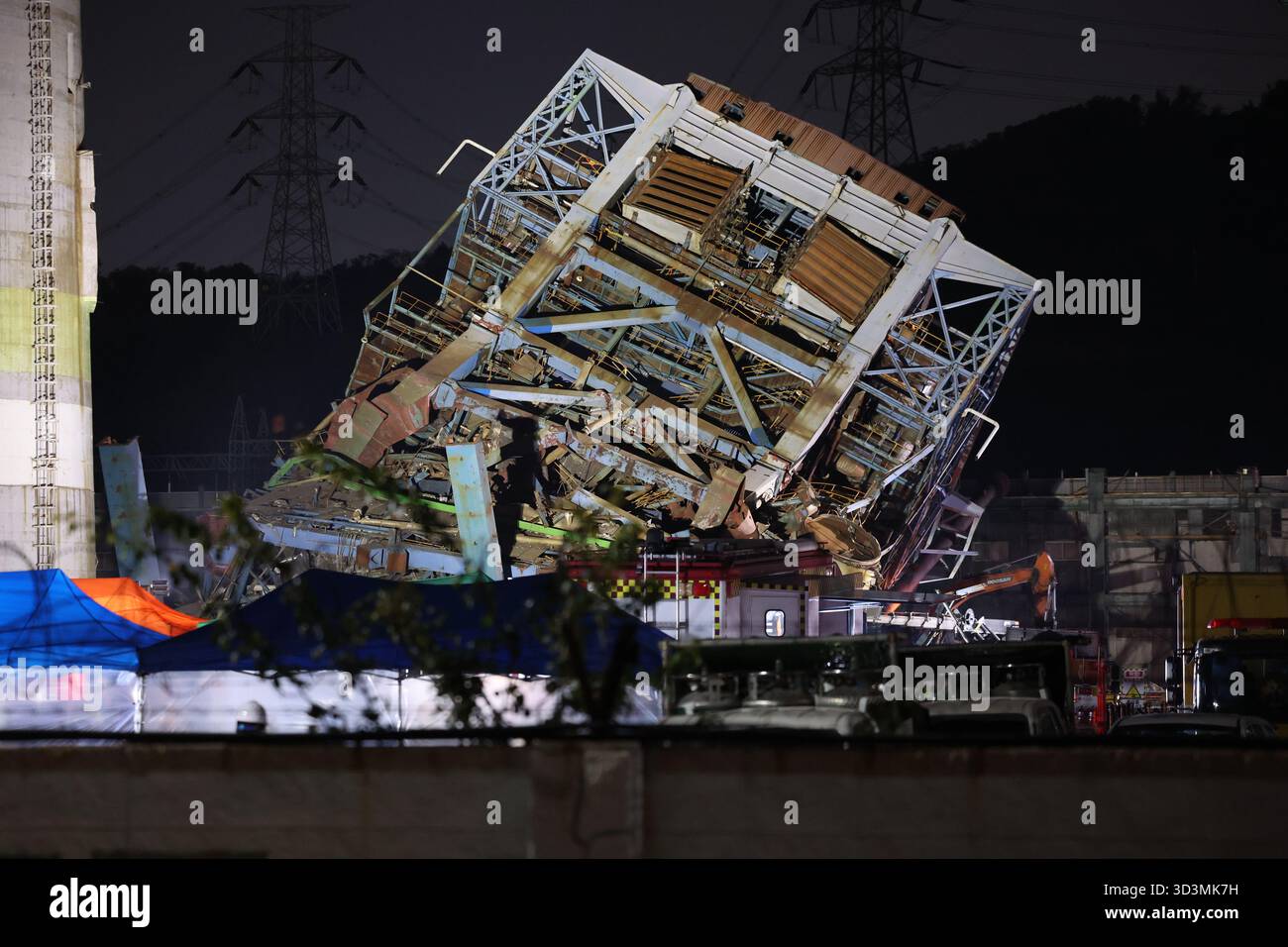 A 60-meter (196-foot) tower collapses during demolition work at a ...