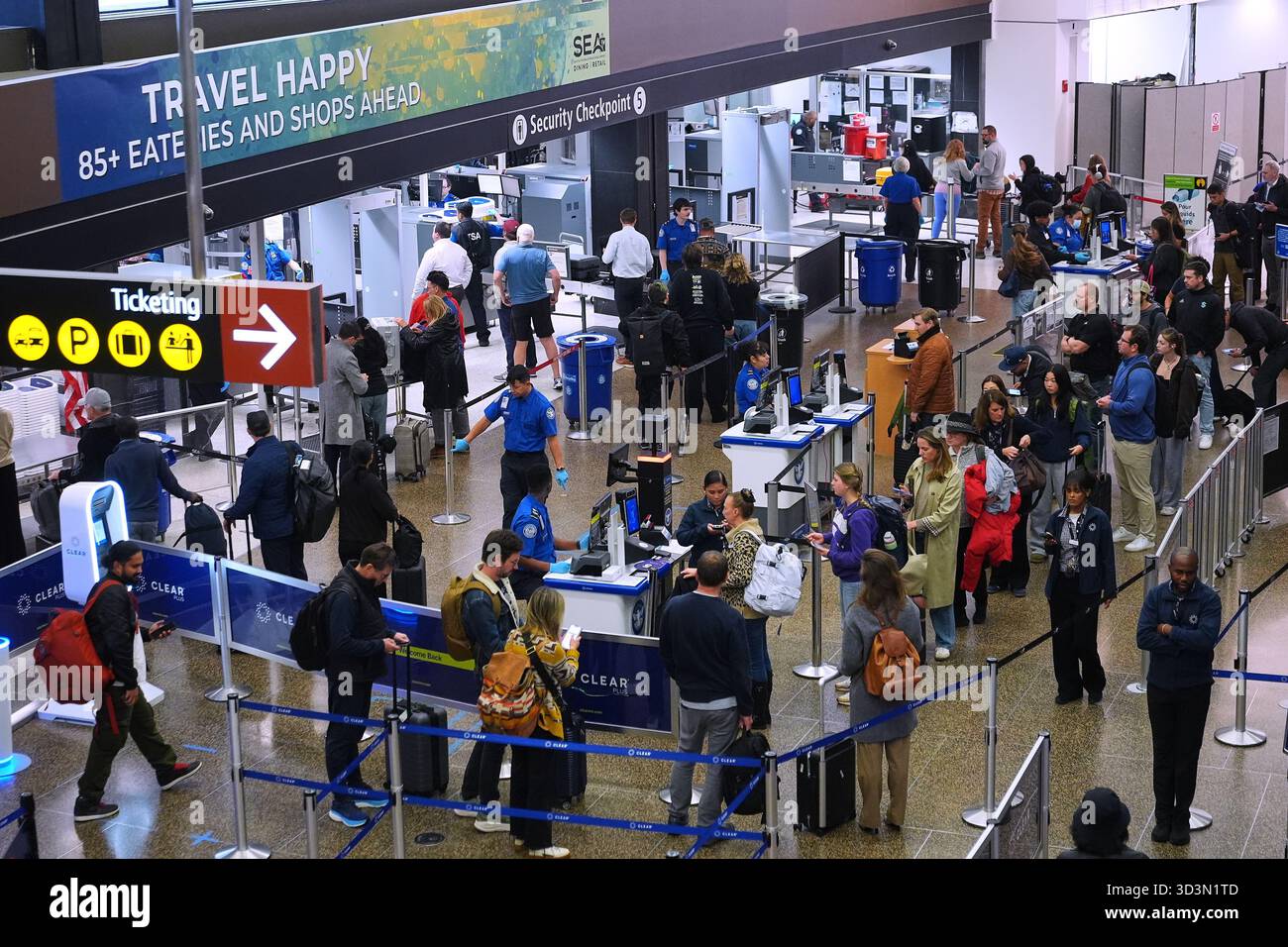 Travelers go through TSA airport security at Seattle-Tacoma ...