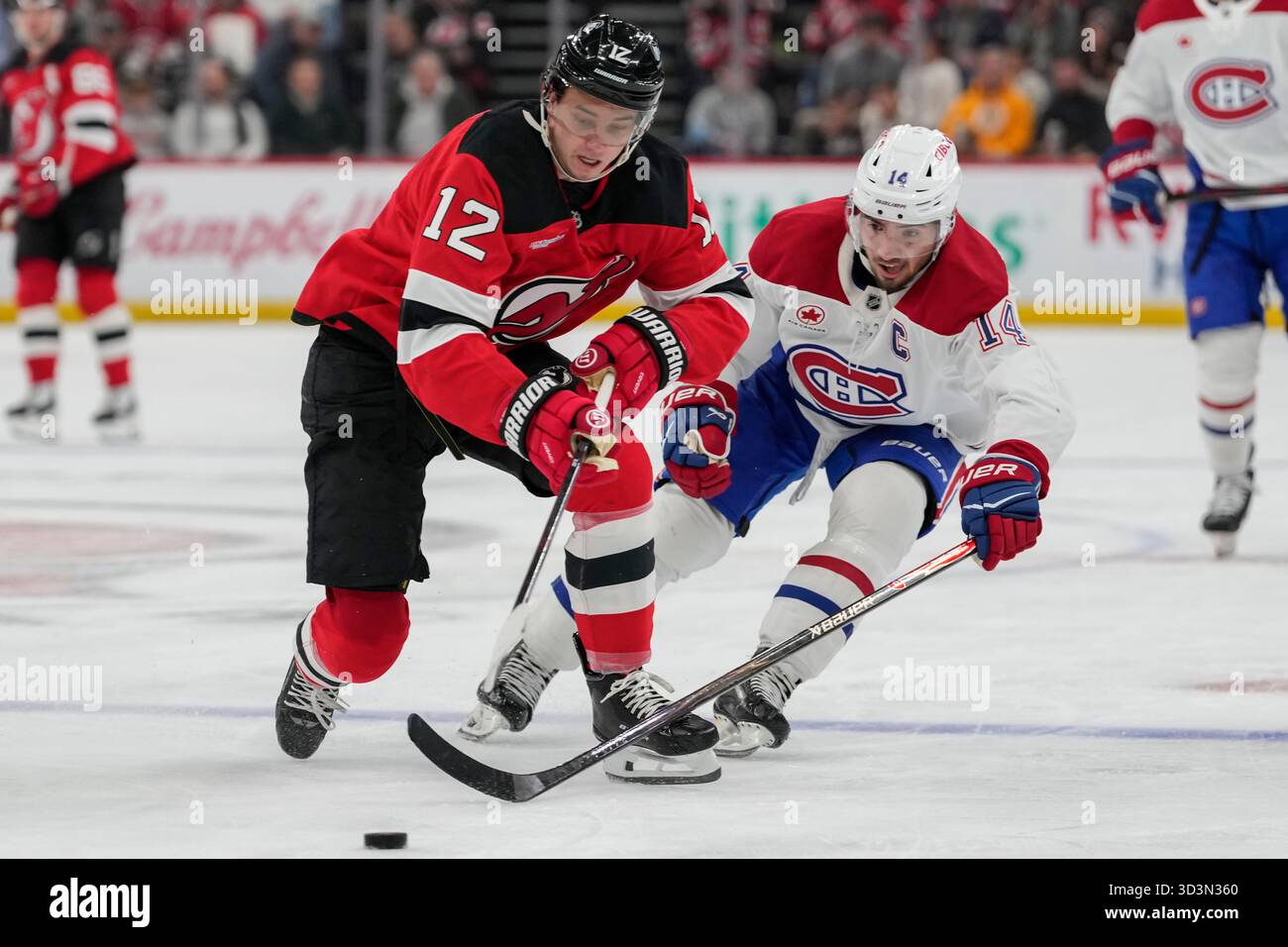 New Jersey Devils center Cody Glass (12) fights for control of the puck ...