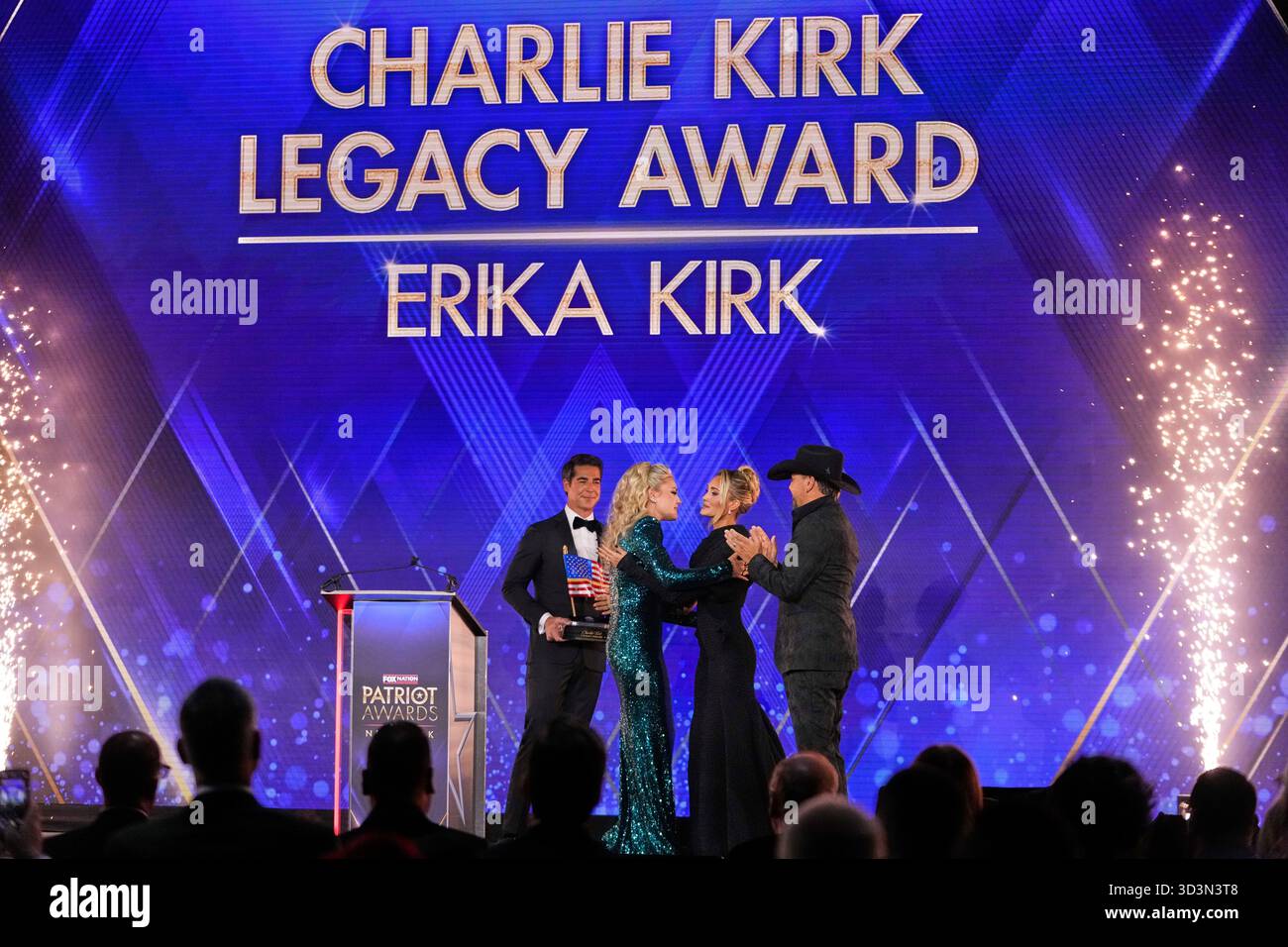 Jesse Watters, left, and Jason Aldean, right, watch Erika Kirk embrace Brittany Aldean during ...