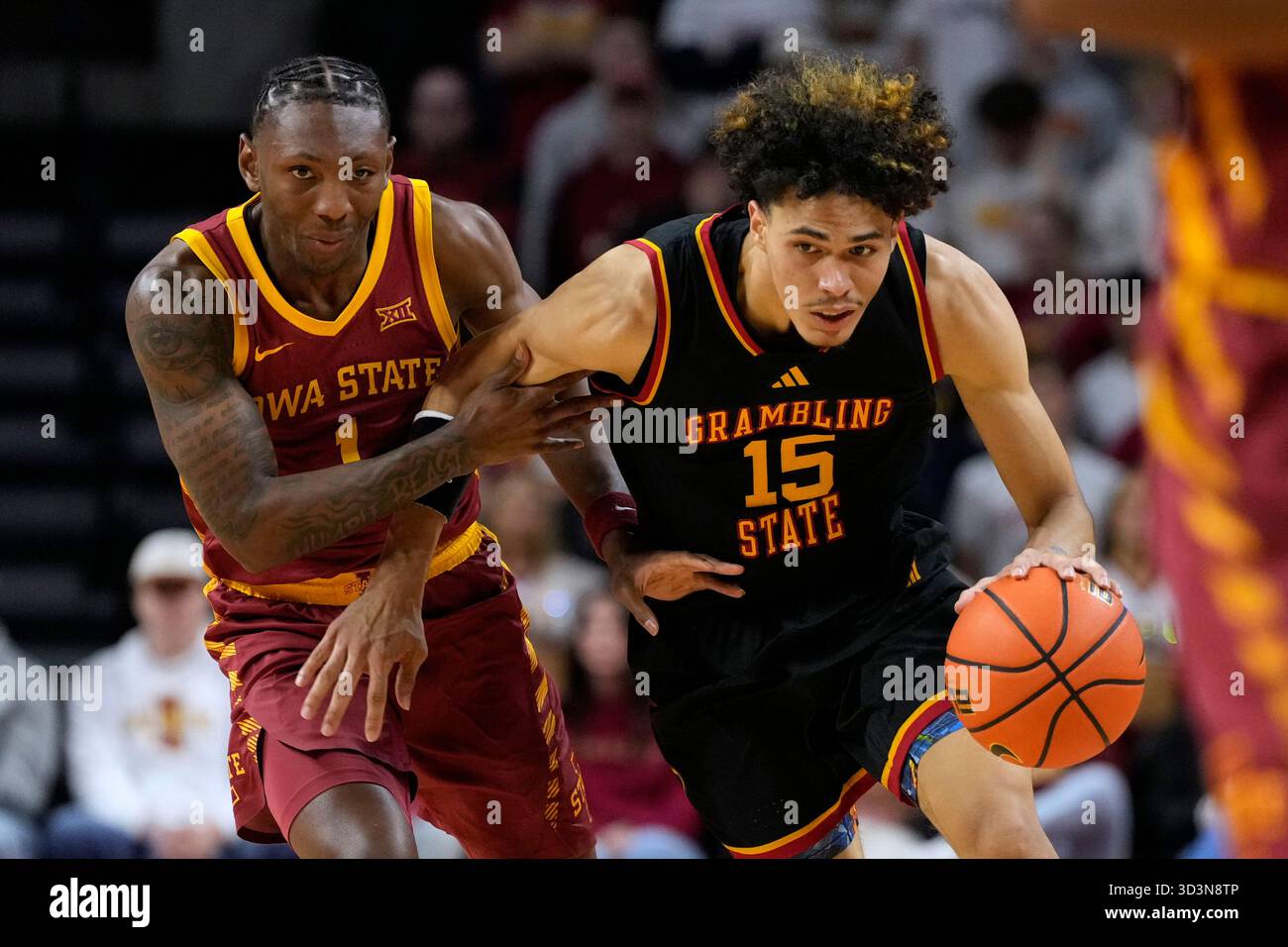 Grambling State forward Antonio Munoz (15) drives up court past Iowa ...