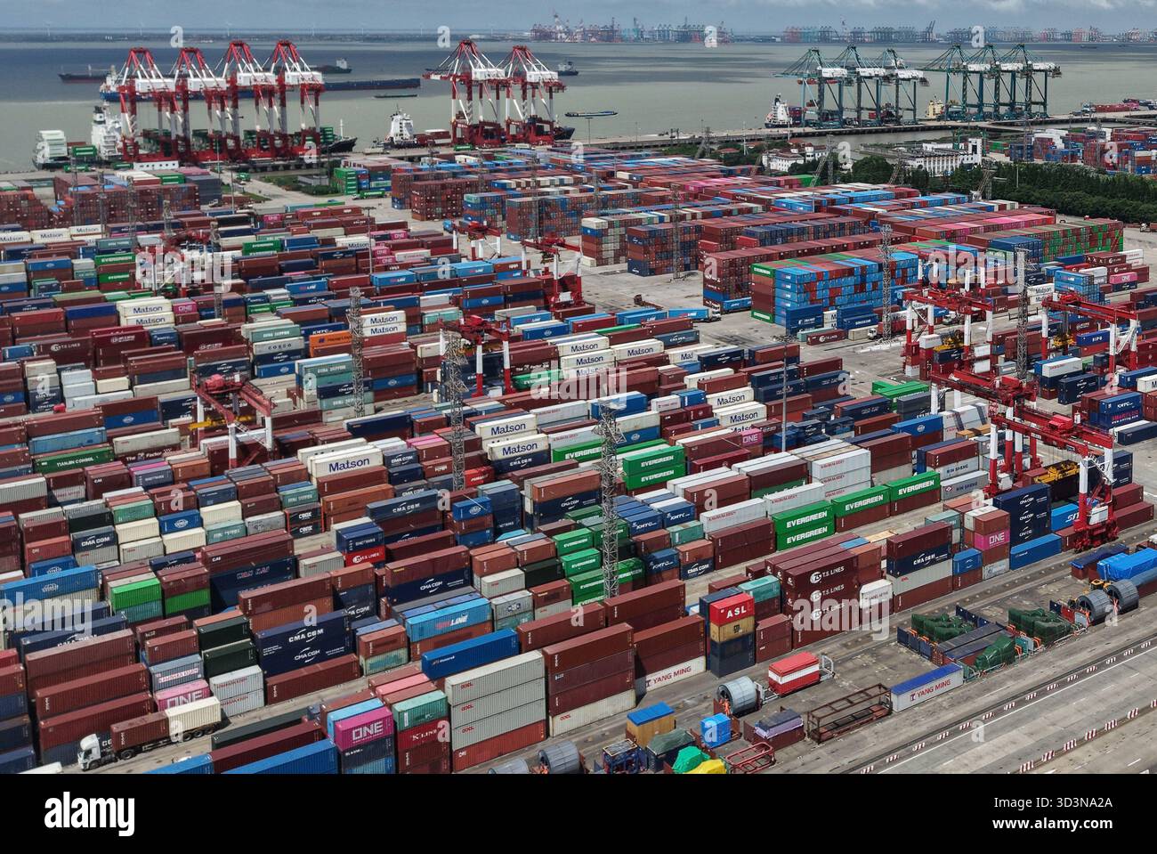 SHANGHAI, CHINA - NOVEMBER 7, 2025 - Vehicles transport containers back ...