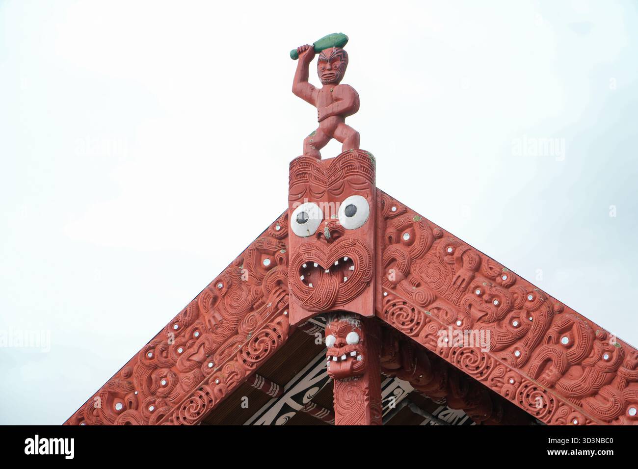 Maori carving on a traditional meeting house (wharenui) roof, with ...