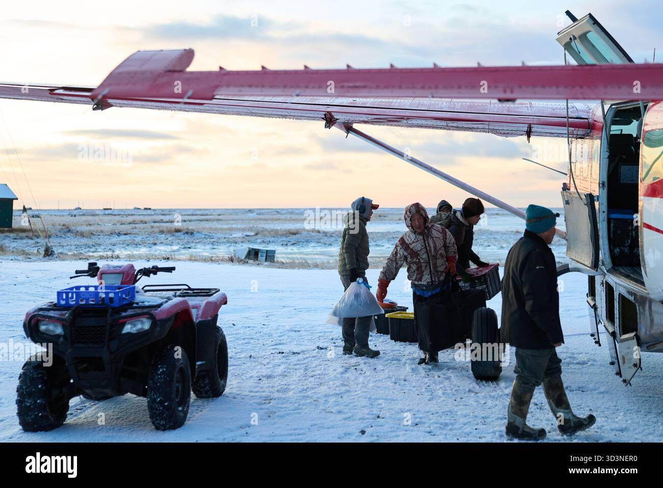 People load crates into an outbound flight from Kwigillingok, Alaska ...