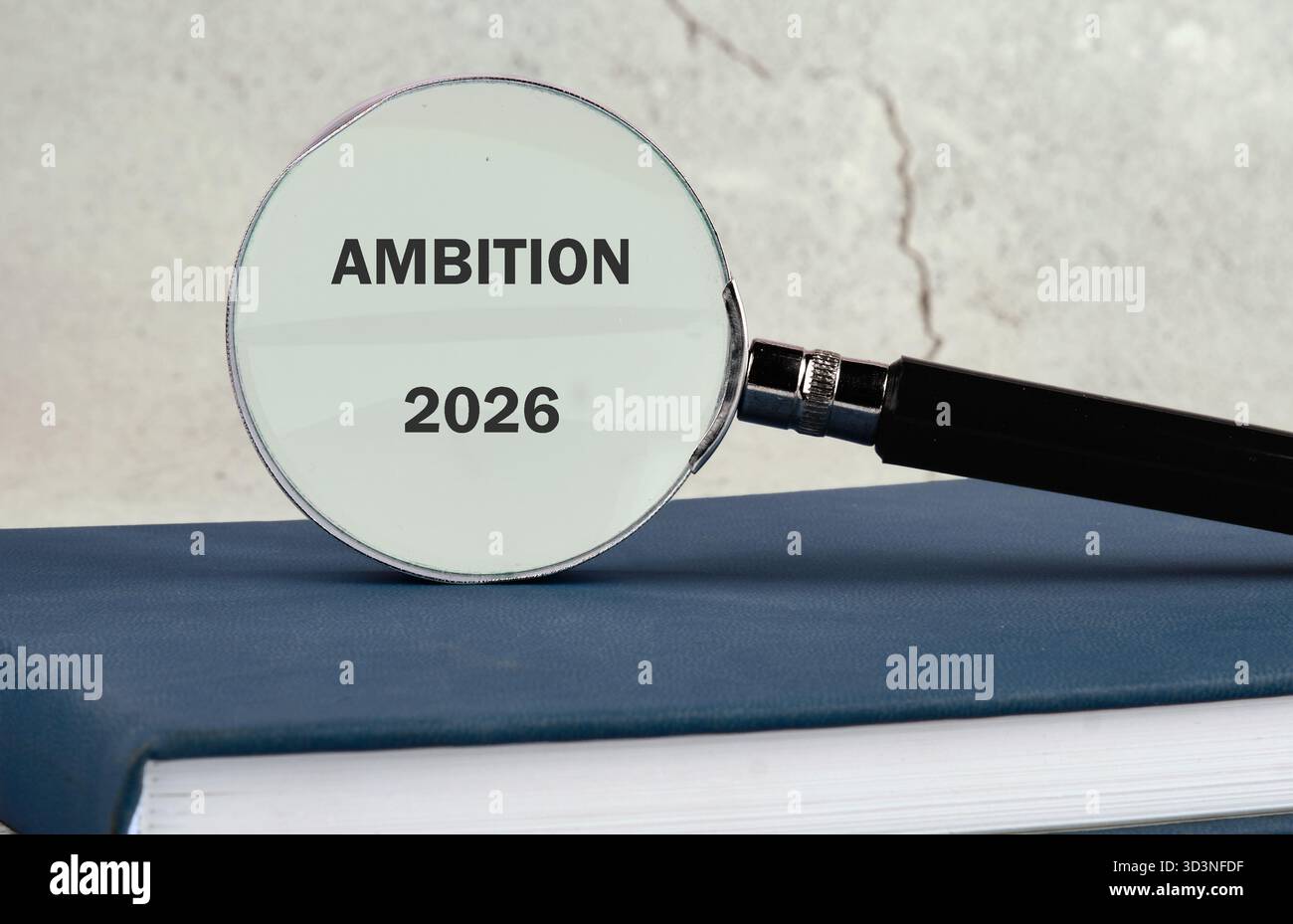 A magnifying glass highlighting the word ambition alongside the year ...