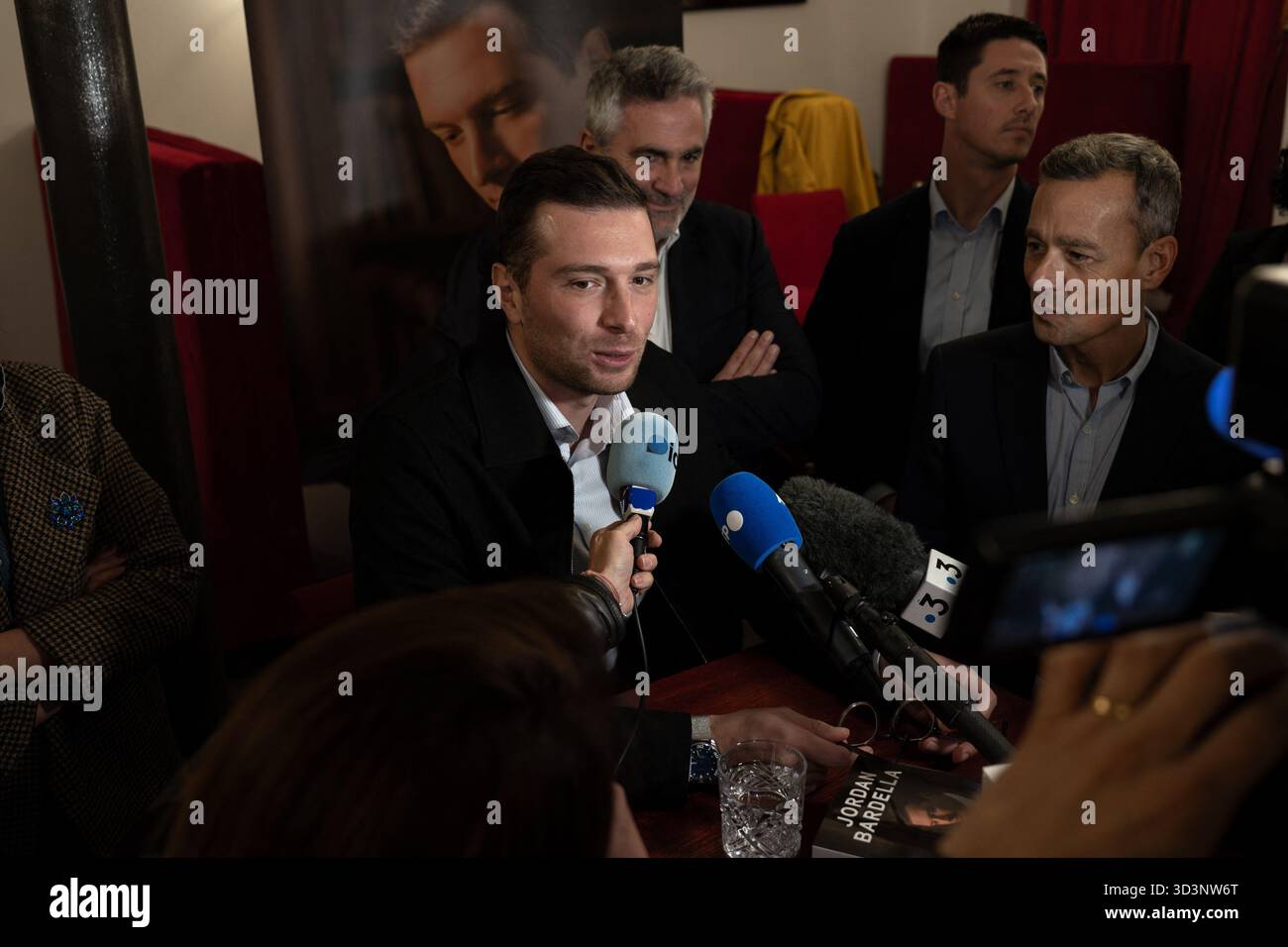 Jordan Bardella answers questions from the press before signing copies ...