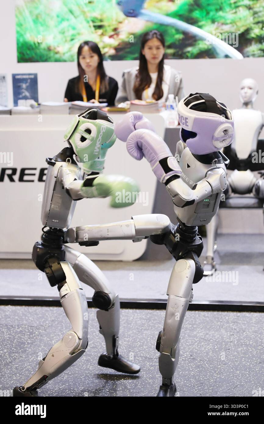 Visitors watch a robot boxing game at the 8th China International ...