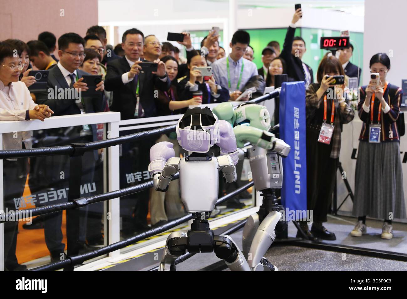 Visitors watch a robot boxing game at the 8th China International ...
