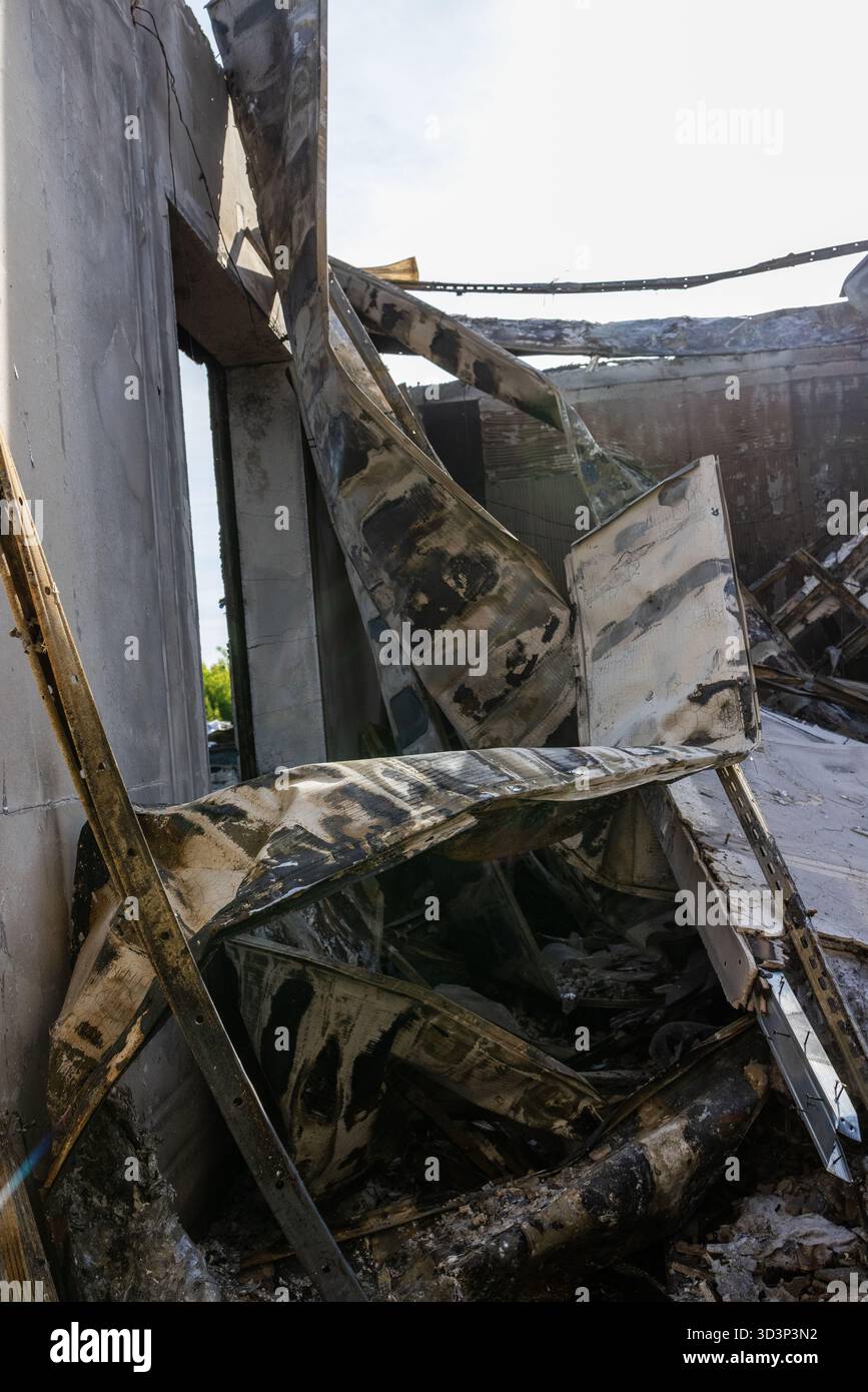 Daylit aerial view of fire aftermath twisted metal panels, scorched ...
