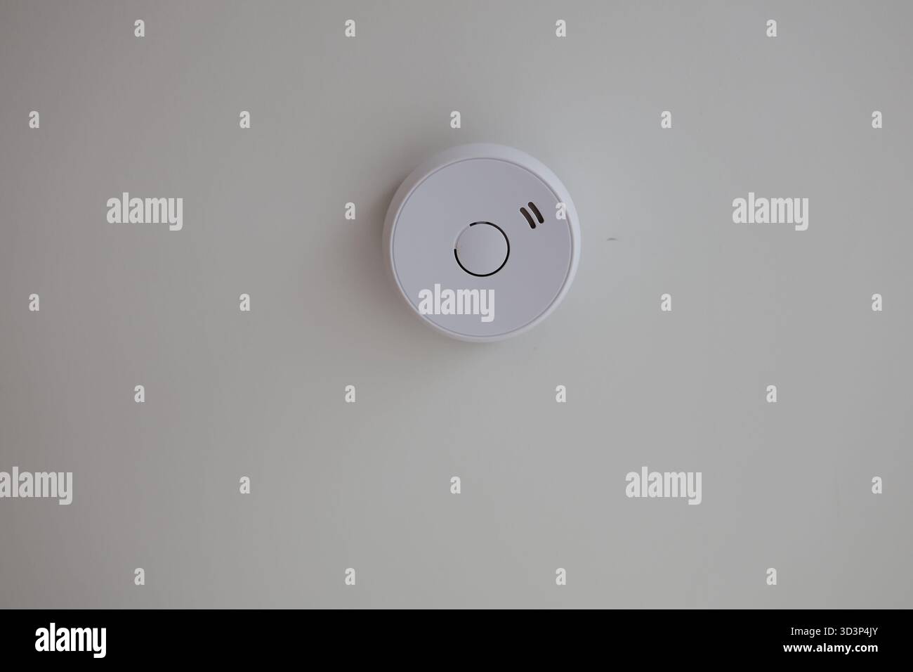Round smoke detector on ceiling Stock Photo - Alamy