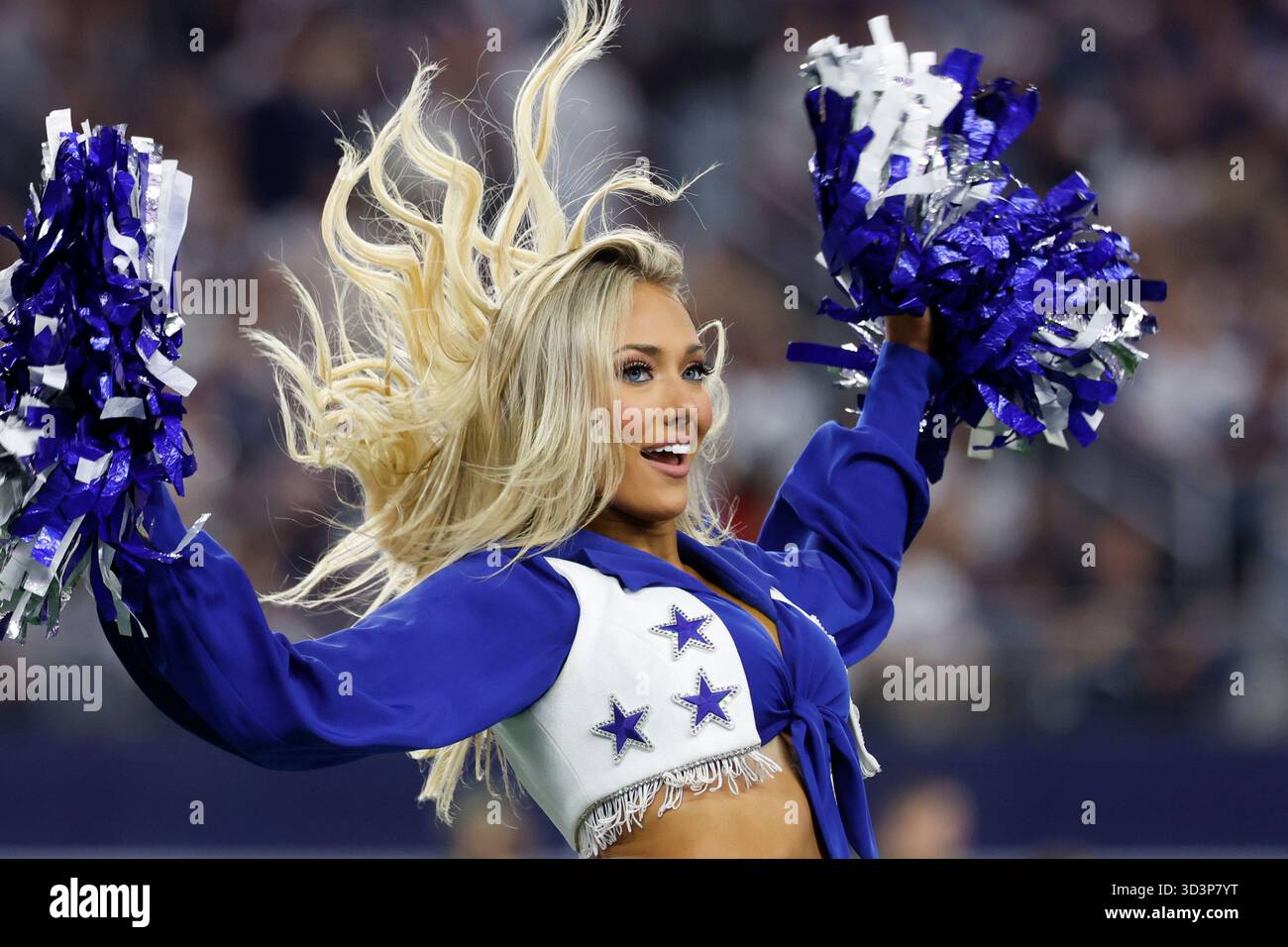 A Dallas Cowboys cheerleader performs during a NFL football game ...