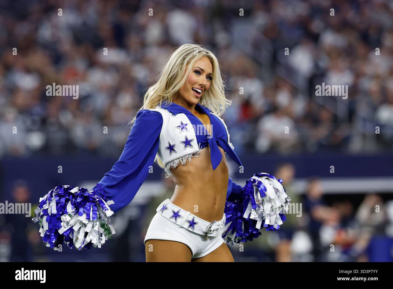 A Dallas Cowboys cheerleader performs during a NFL football game ...