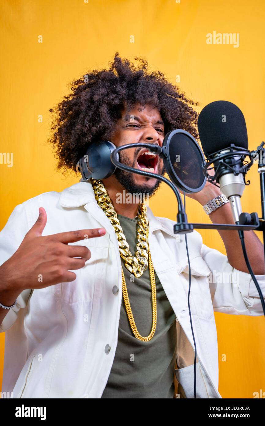 Black man rapper performing music into studio microphone Stock Photo ...