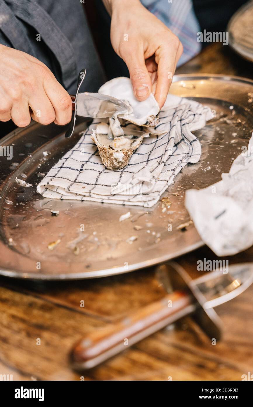 Professional chef opens oyster knife hi-res stock photography and ...