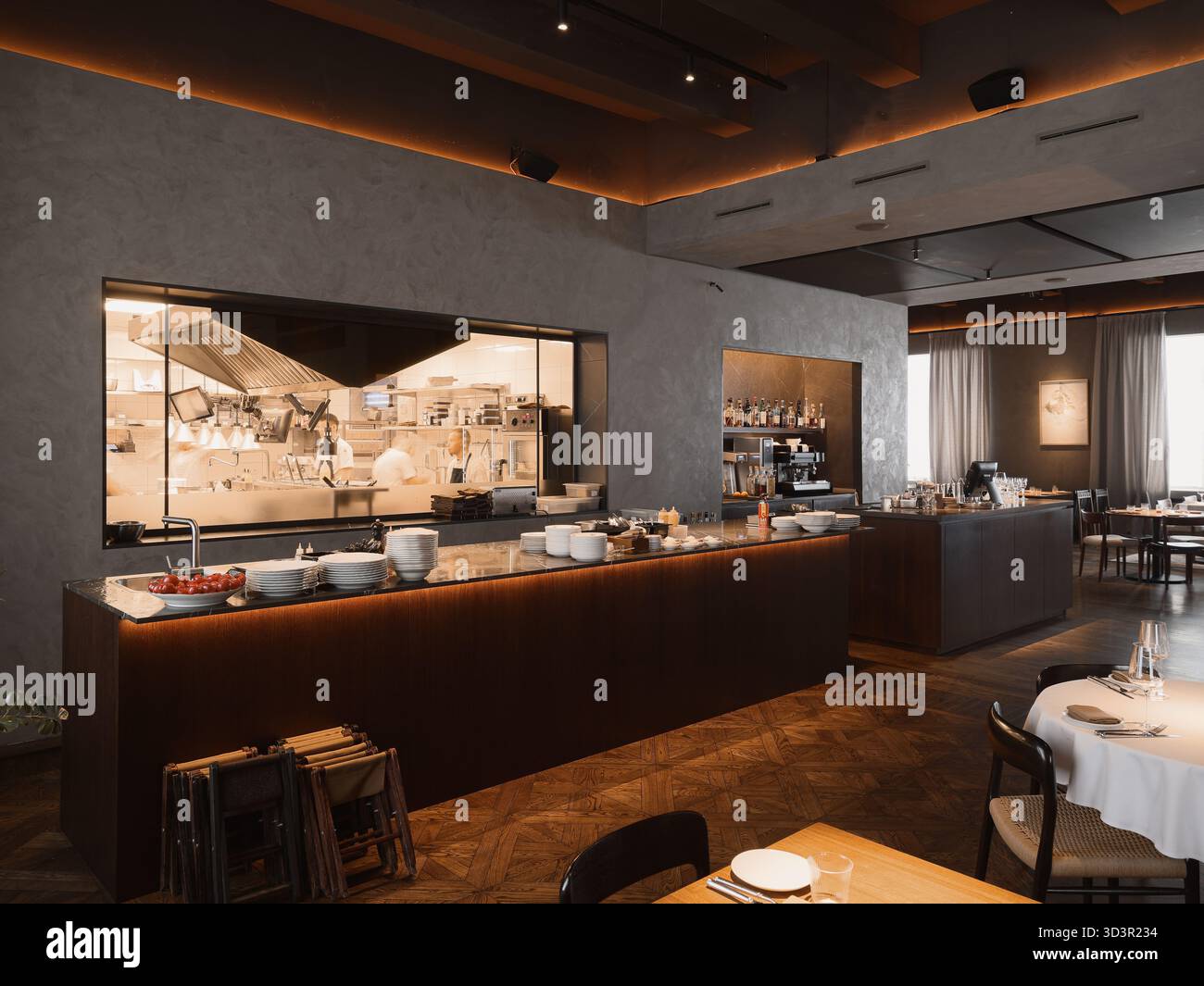 Elegant dining area with modern kitchen view in a classy restaurant ...
