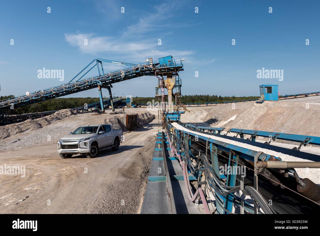 Bright sunlight illuminates open industrial potassium mining site blue ...
