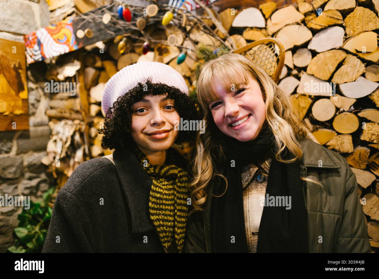Black and white sisters in law smile together in rustic wooden Stock ...