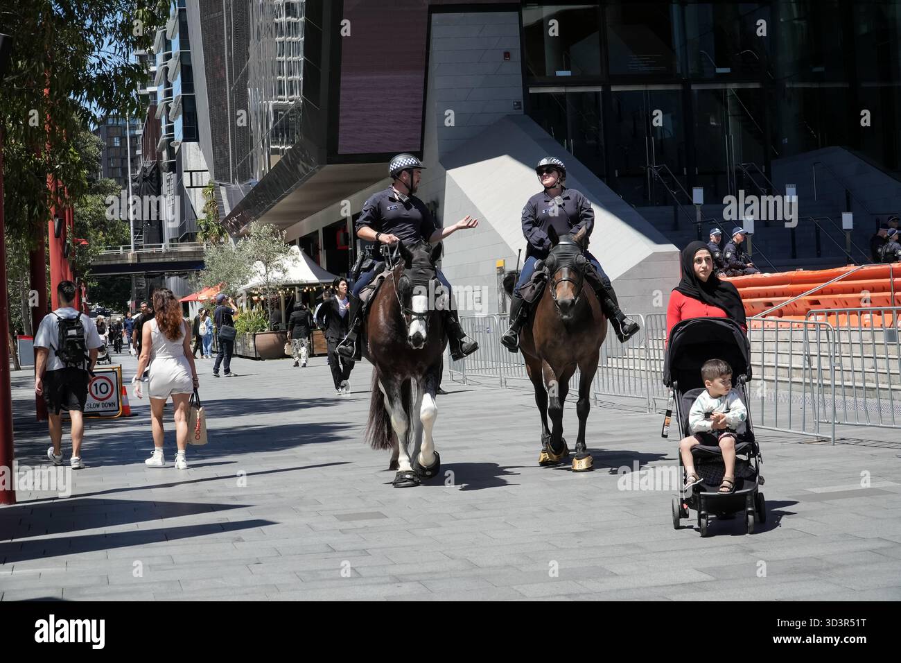 Mounted police officers from the NSW Mounted Police Unit patrol a busy ...