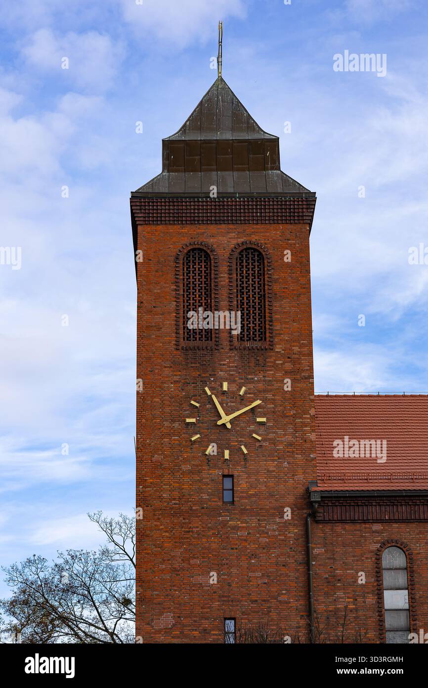 The brick tower features a prominent clock face and intricate ...